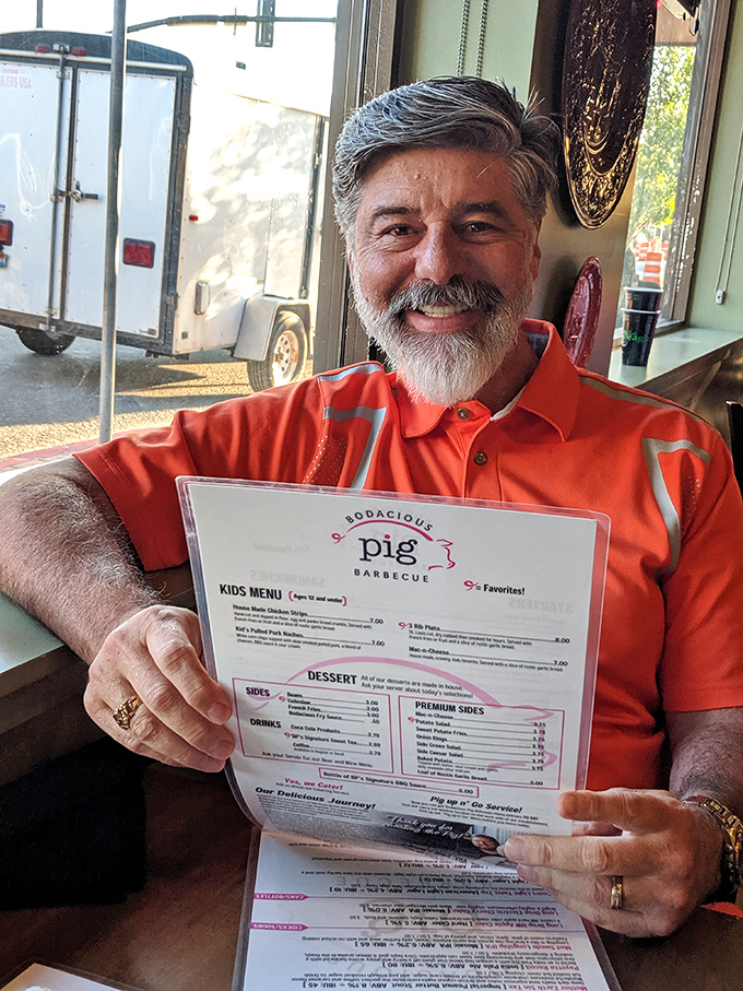 The joy of barbecue, captured in one smile. This diner's expression says what words can't – "I've found my happy place, and it smells like smoked meat."