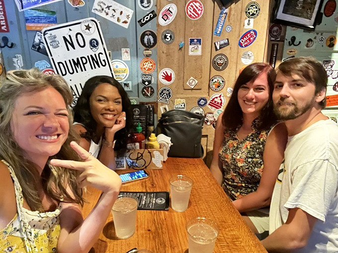 Happy faces and cold drinks&mdash;the universal symbols of good times. That wall of memorabilia has witnessed countless burger epiphanies.