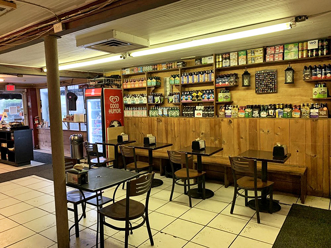 The dining area feels like it evolved organically over years, with wooden paneling and shelves stocked with bottles promising post-meal browsing.