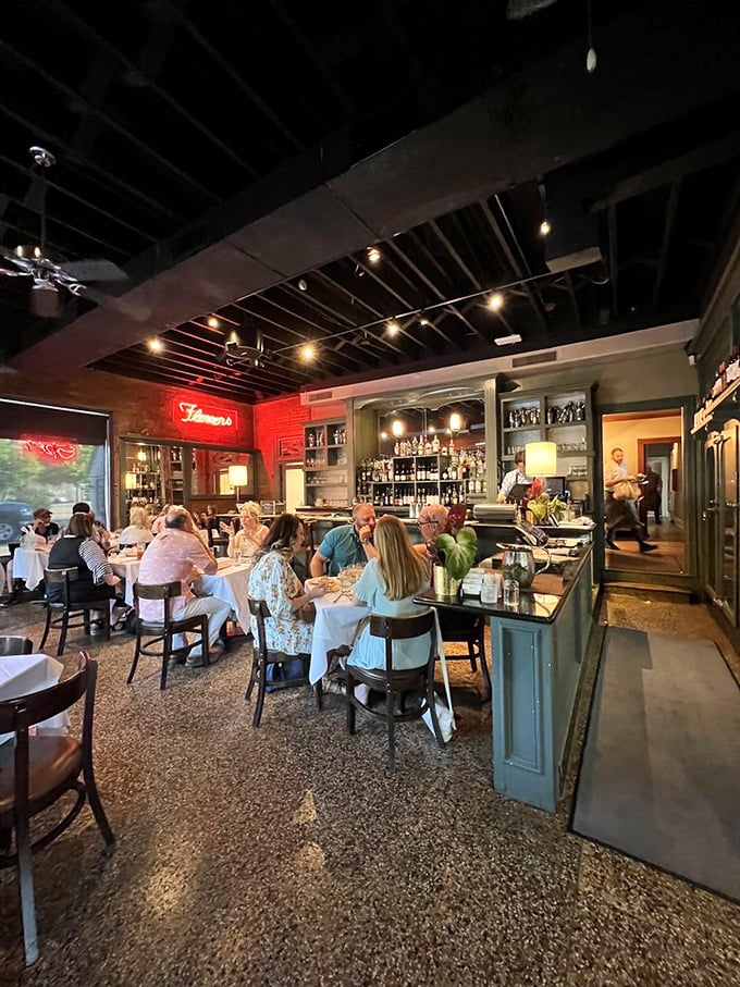 A dining room humming with conversation and satisfaction. The soft lighting flatters both the food and those enjoying it.
