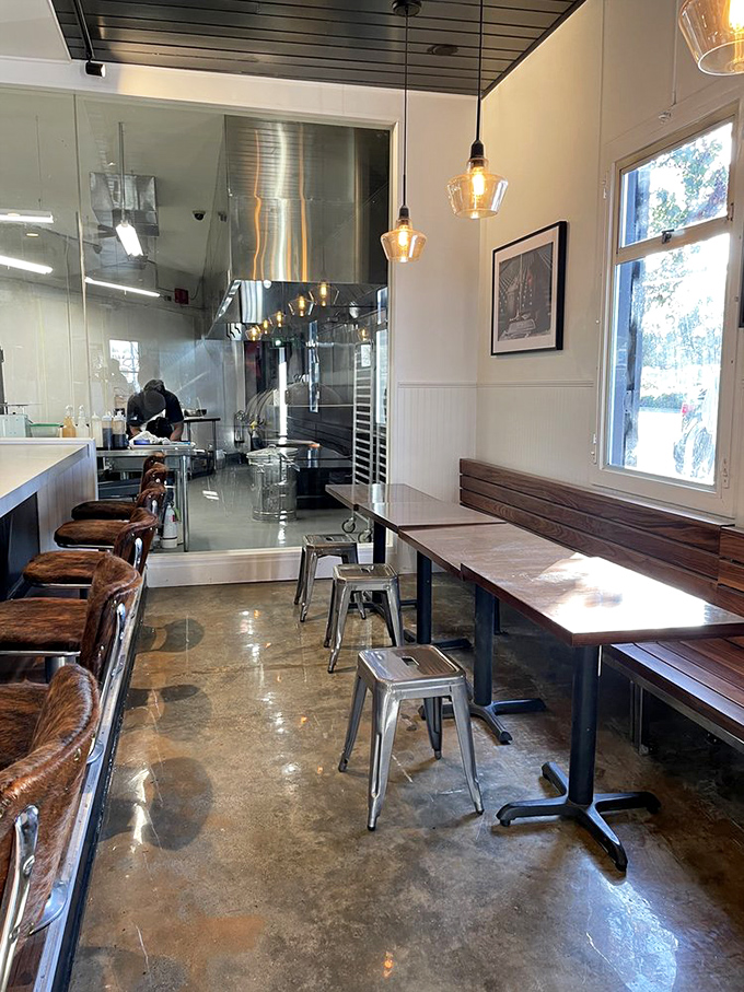 Minimalist dining space where nothing distracts from the main event. Those pendant lights cast a glow that makes everyone look like they're having a religious experience.