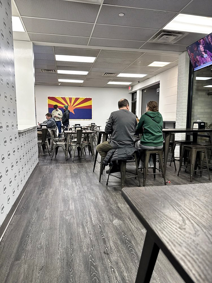 The Arizona state flag watches over diners like a proud parent, ensuring every bite stays true to its sun-baked heritage.