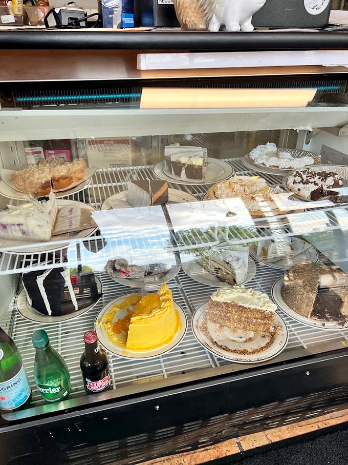 A dessert case that whispers sweet nothings to your willpower. That yellow cake is practically winking at you from behind the glass.