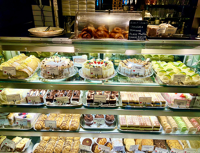 The glass case of temptation where diet resolutions go to die. Each shelf offers a different European vacation without the airfare.