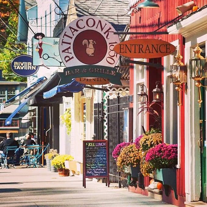 Colorful flowers and unique signs greet you as you stroll down this vibrant sidewalk filled with local dining and charm.