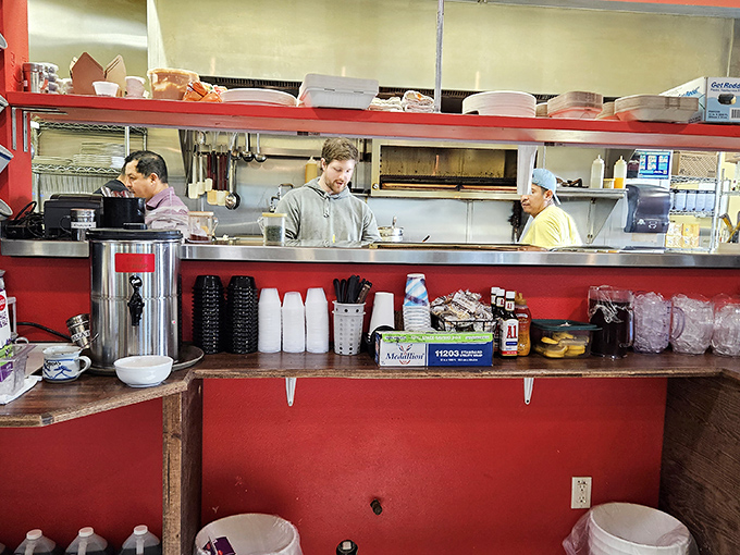 The open kitchen concept lets you witness culinary choreography in action, with staff who move with practiced precision.