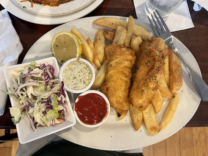 Fish and chips that would make a British pub regular homesick. The coleslaw adds a splash of color to this golden masterpiece.