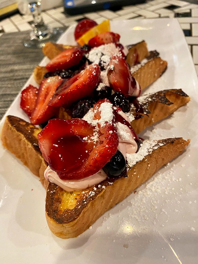 French toast that's dressed for success with berries, cream, and enough powdered sugar to make your dentist wince. Worth every sweet bite.
