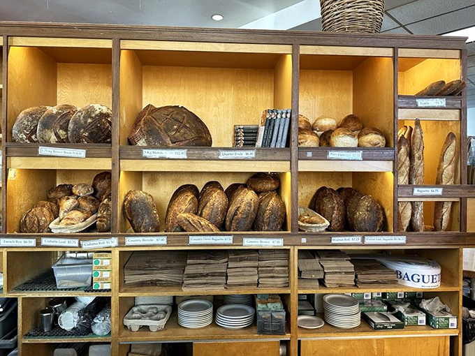 The bread wall&mdash;a museum of crusty, golden loaves that would make any cardiologist weep. Each variety tells a different story of fermentation, patience, and perfect timing. 