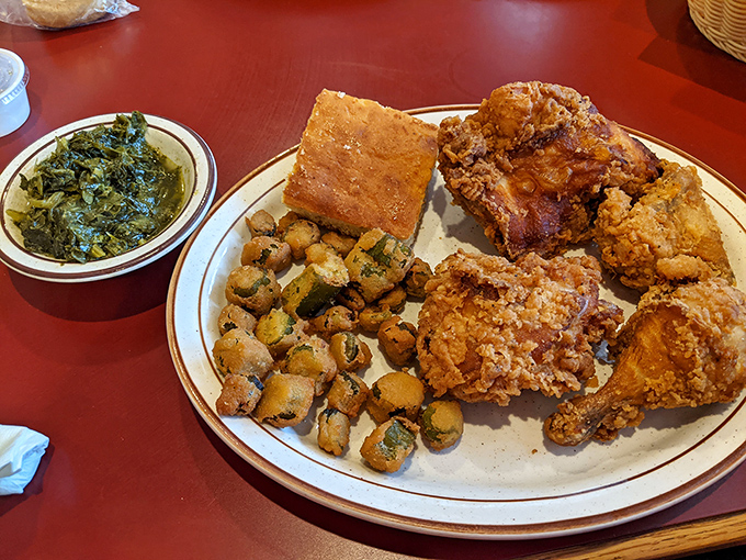 A Southern trinity: fried chicken, cornbread, and collards. This isn't just a meal—it's a cultural dissertation on a plate.