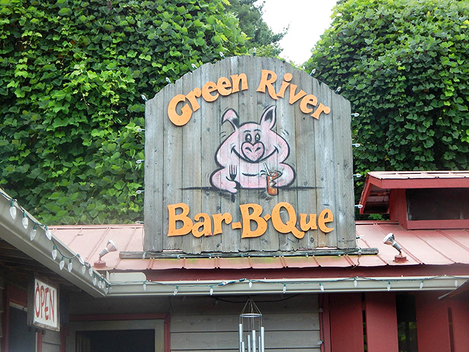 Green River BBQ's sign promises exactly what you'll get &ndash; pork so good it deserves its own cartoon mascot raising a celebratory drink.