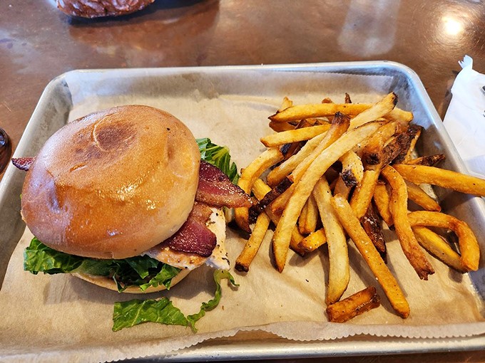 This isn't just a sandwich; it's architecture with flavor&mdash;layers of goodness stacked between bread with fries standing guard.