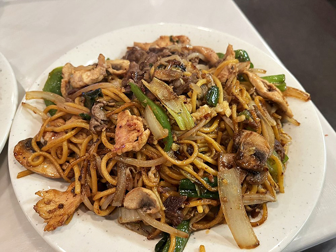 This isn't just lo mein—it's a tangle of noodles playing host to a party where chicken, beef, and vegetables are all invited guests.