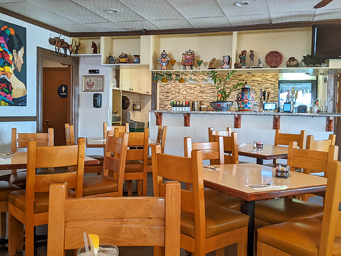 The dining room says "stay awhile" without saying a word. Wooden chairs and Mexican folk art create an atmosphere where memories are made between bites.