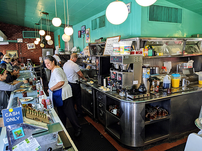 The command center where breakfast dreams materialize. No molecular gastronomy here &ndash; just skilled hands and well-seasoned equipment doing the real work.