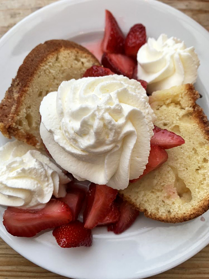 Pound cake elevated to art form with fresh strawberries and clouds of whipped cream. Dessert that makes you pause mid-conversation to appreciate life.