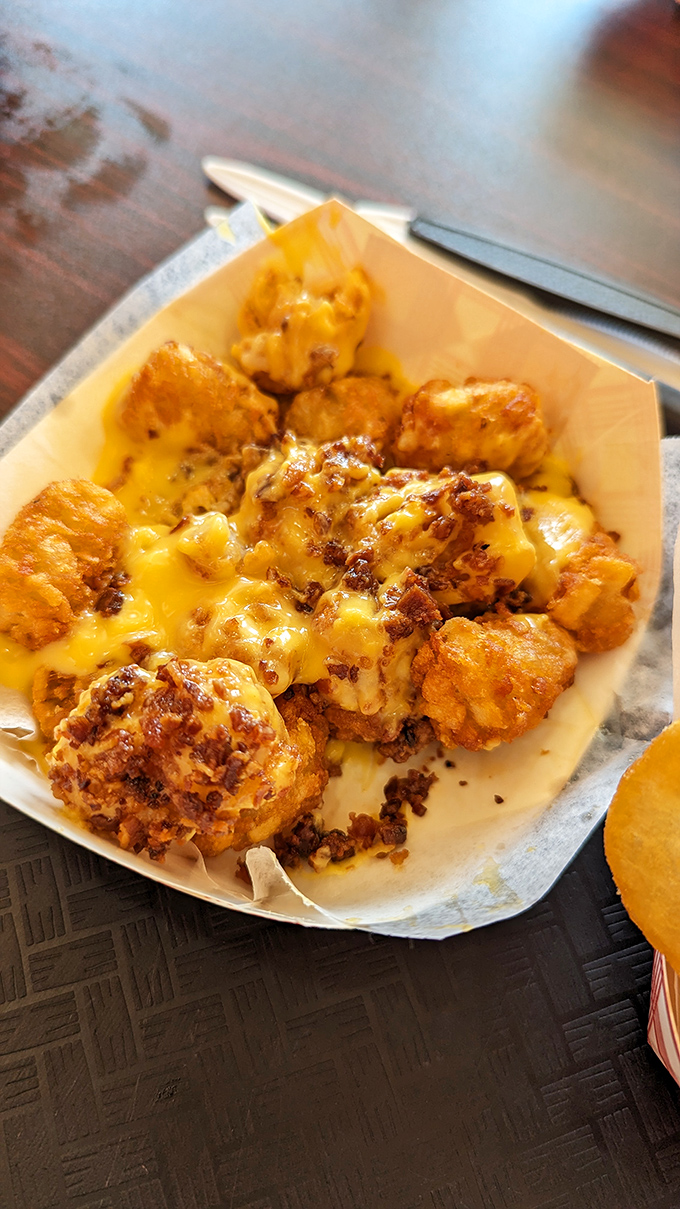 Tater tots smothered in cheese and bacon bits &ndash; the dish that makes sharing both necessary and nearly impossible.