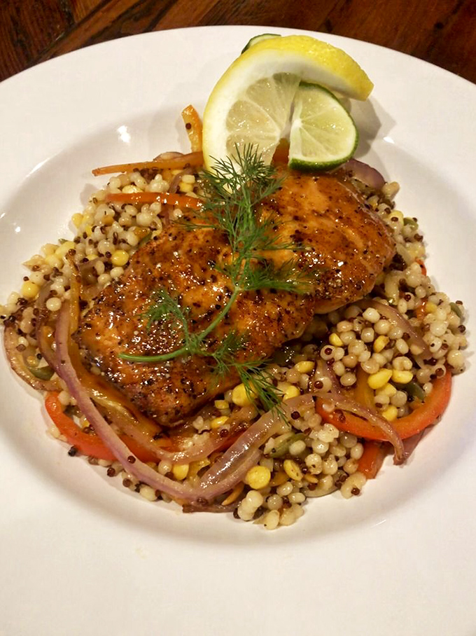This salmon isn't just dinner; it's a celebration of the Pacific, perched atop a colorful island of grains and vegetables like edible artwork.