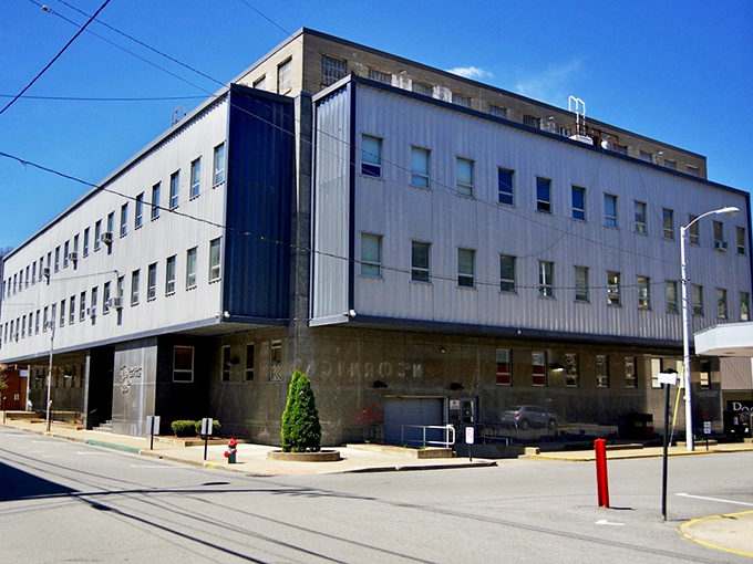 The Logan County Courthouse anchors downtown with dignified permanence, its brick facade having witnessed generations of mountain life unfolding around it.