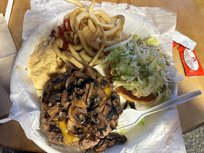A burger topped with saut&eacute;ed mushrooms proves that sometimes the best relationships are built on a foundation of cheese.