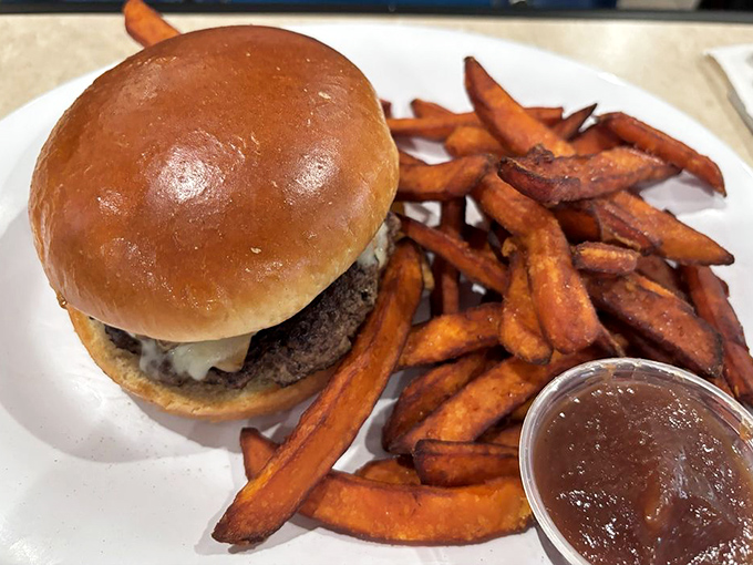 A burger that demands to be photographed before eaten, with sweet potato fries that upstage even the most photogenic sandwich.