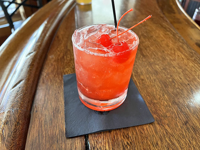 The vibrant red cocktail, adorned with cherries, isn't just a drink&mdash;it's liquid ruby that promises good times ahead.
