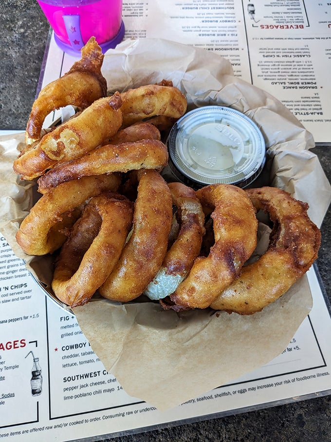 Onion rings that deserve their own fan club – golden halos of crispy batter surrounding sweet onion that surrenders with each perfect bite.