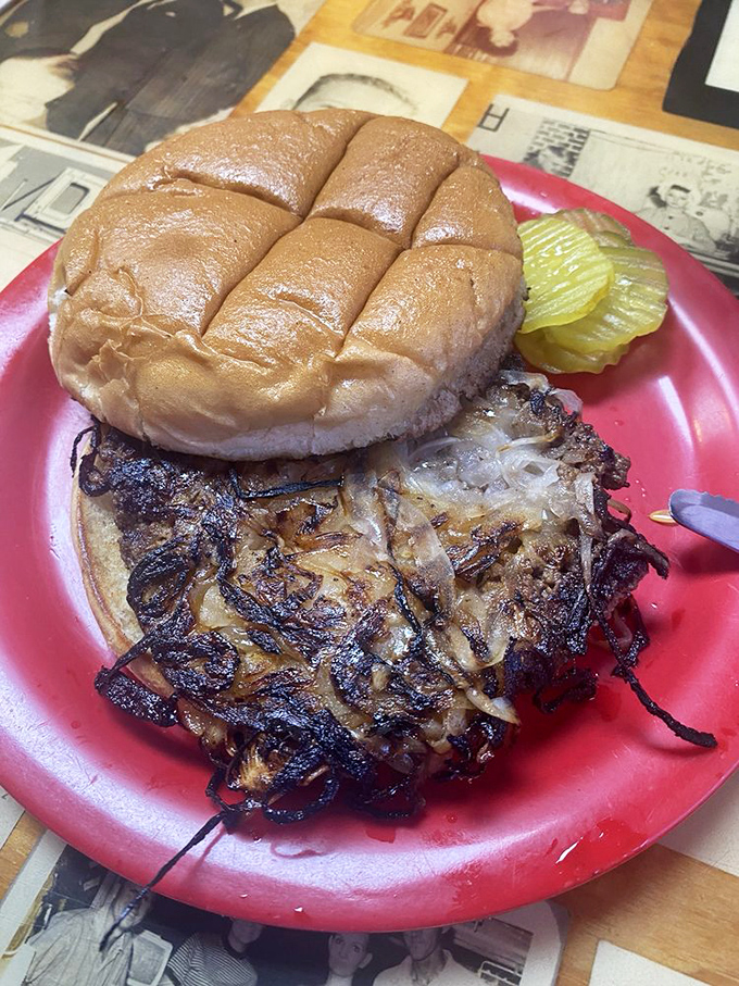 The onion burger in its natural habitat&mdash;crispy edges, soft bun, and those glorious caramelized onions spilling out like they own the place.