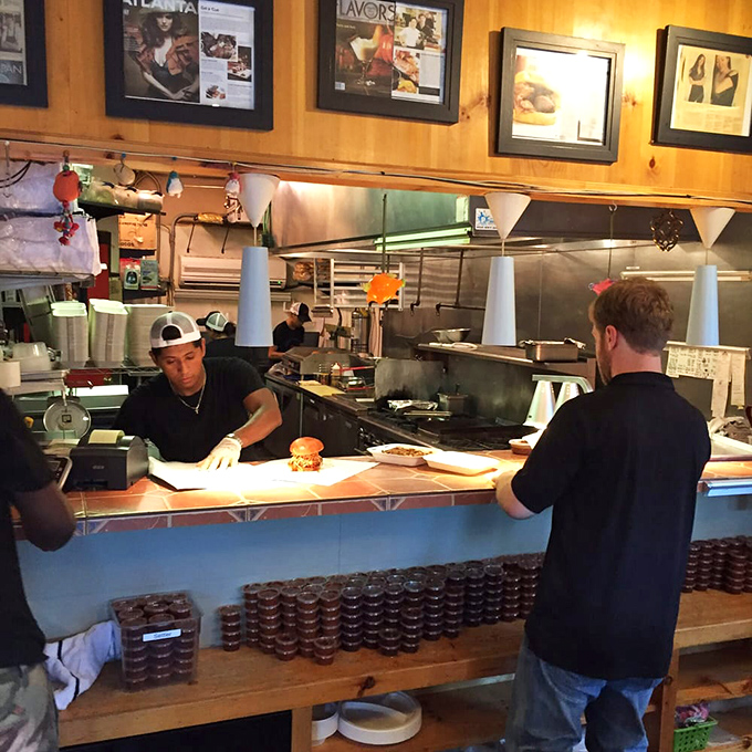 The open kitchen lets you witness the choreographed precision of pitmasters who have elevated barbecue to an art form.