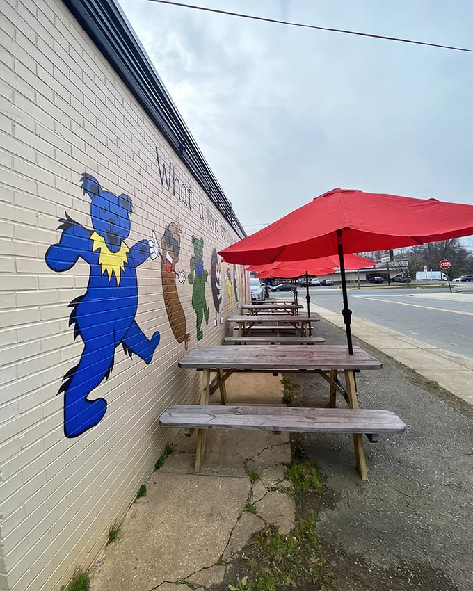 Whimsical wall art watches over picnic tables where outdoor diners savor their treasures. Simple pleasures in the Carolina sunshine.