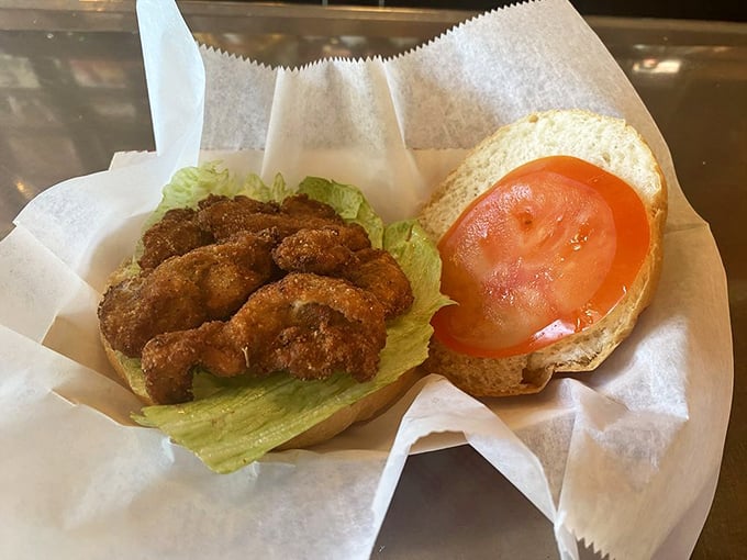 The oyster sandwich&mdash;proof that the universe loves us. Crispy, briny treasures nestled in bread with fresh tomato and lettuce for guilt-free balance.