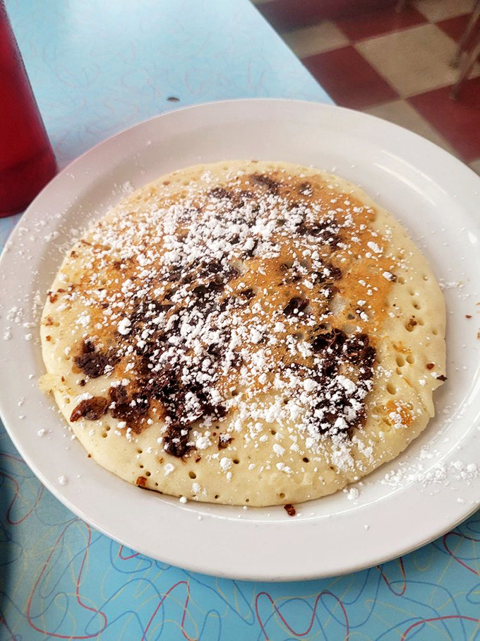 A pancake that's crossed the line from breakfast to dessert territory, dusted with powdered sugar like the first perfect snowfall of winter.