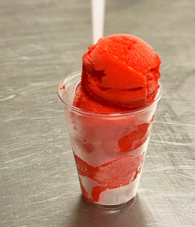 A cup of vibrant red water ice—Philadelphia's favorite frozen treat that's somewhere between sorbet and a slushy. Summer in a cup, no matter the season.