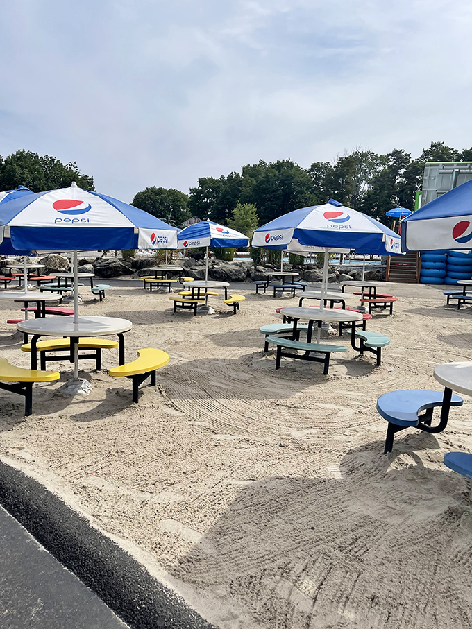 Pepsi umbrellas shade colorful picnic tables, creating the perfect refueling stations for waterlogged adventurers needing to recharge.