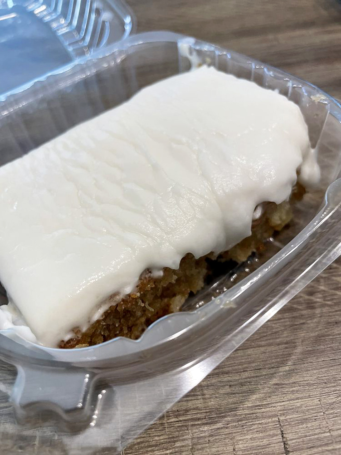 Beneath that smooth cream cheese frosting lies a moist pineapple cake waiting to provide sweet relief after your savory meat journey.