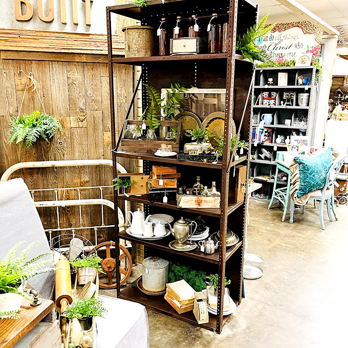 Industrial shelving meets farmhouse chic in this booth where vintage teapots and weathered books create an Instagram-worthy vignette without even trying.