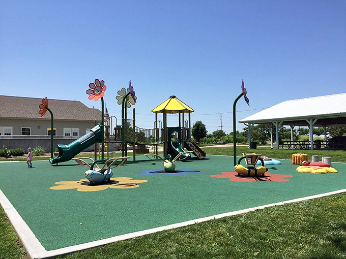 This playground's whimsical flower sculptures and bright colors make me wish adult-sized slides were socially acceptable after age 12.
