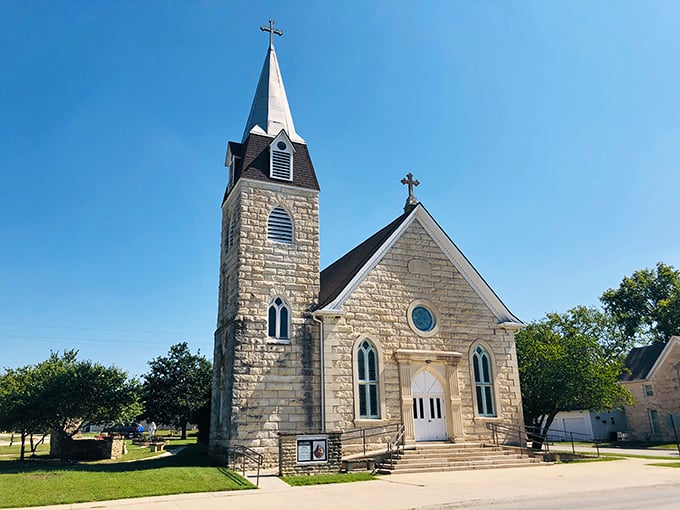 St. Anthony's limestone church stands sentinel over Strong City, its steeple reaching skyward like the spiritual heart of the community.