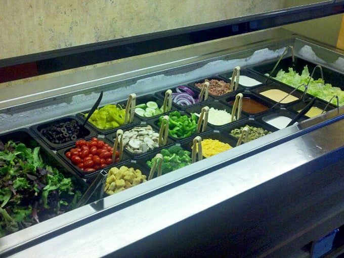 The salad bar of champions. Fresh ingredients lined up like soldiers ready to march onto your plate or pizza&mdash;your choice, no judgment.