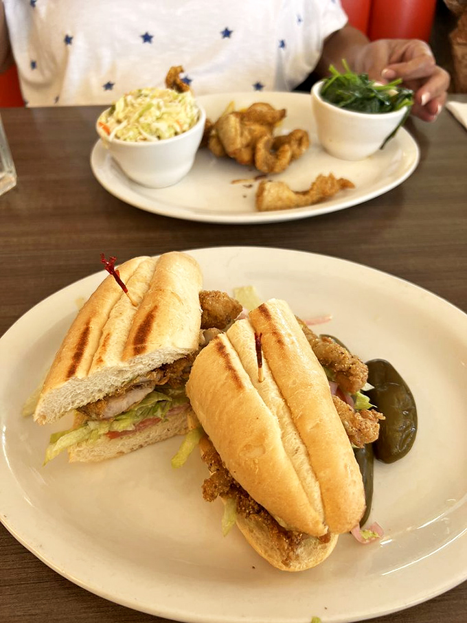 A sandwich so perfectly constructed it deserves its own blueprint &ndash; crispy bread, generous filling, and those pickles standing guard like delicious sentinels.