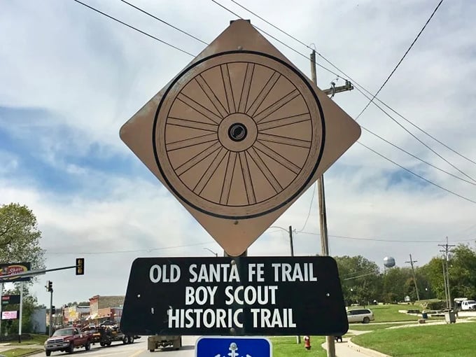 The Santa Fe Trail wheel sign marks where countless wagons once rolled west, carrying dreams and determination.