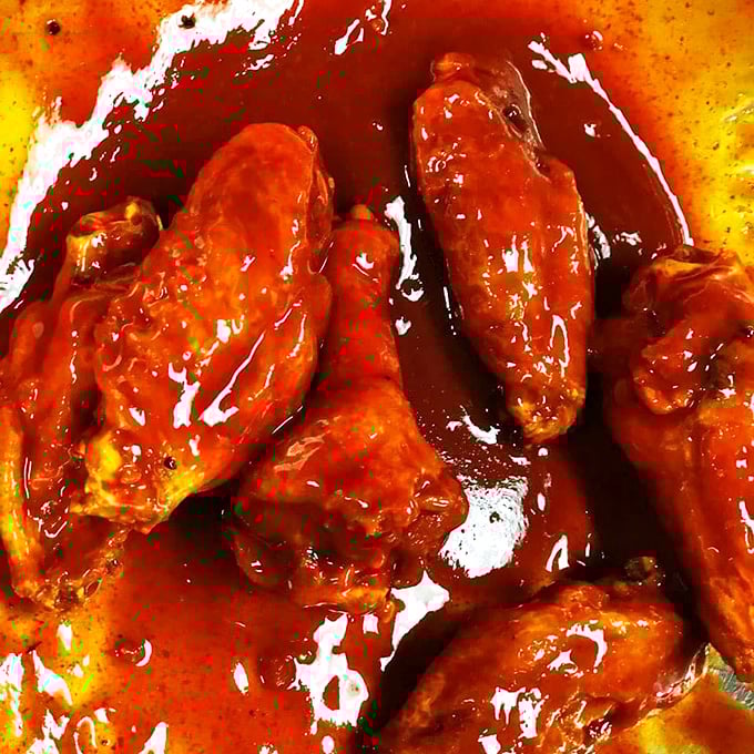 Wings so gloriously sauced they practically dare you to maintain your dignity while devouring them&mdash;napkins required, regrets forbidden.