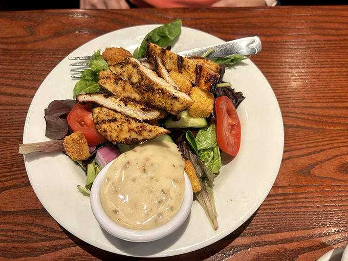 For those who need something green to counterbalance their meat feast—a garden salad with grilled chicken that doesn't feel like punishment.