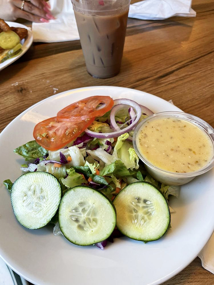 Even the side salad gets respect here&mdash;fresh greens, cucumber rounds, and house dressing prove vegetables aren't just an afterthought.