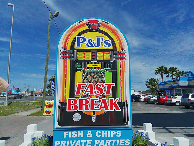 A sign that promises exactly what the 1950s delivered: fast breaks and fish & chips. The jukebox imagery is like a beacon for those seeking nostalgic comfort.