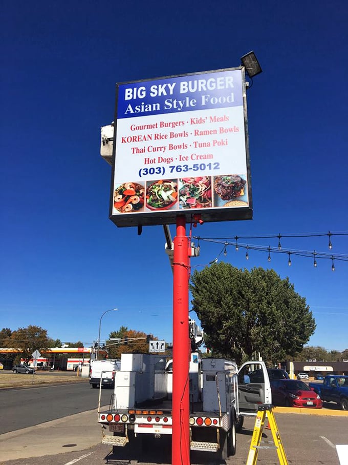The roadside sign reveals Big Sky's surprising secret &ndash; it's not just burgers but a fusion destination offering Korean rice bowls, ramen, and Thai curry alongside American classics.