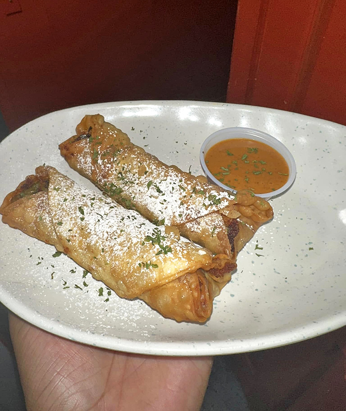 Soul rolls dusted with powdered sugar and served with dipping sauce&mdash;proof that innovation and tradition can be delicious dance partners.