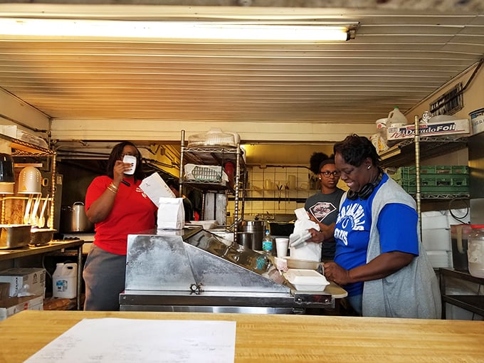 The magic happens behind this counter, where skilled hands transform simple ingredients into memorable meals.