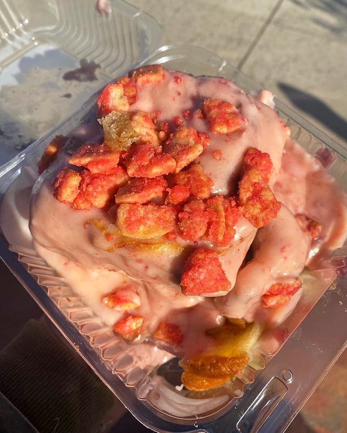 Strawberry crumb cinnamon bun looking like it's wearing a crown of cereal&mdash;breakfast and dessert having an identity crisis we fully support.