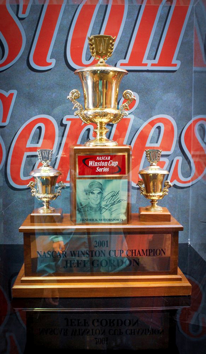 Jeff Gordon's Winston Cup hardware gleams like racing royalty. Trophy cases: where speed becomes immortal and split-second victories are forever frozen in gold.
